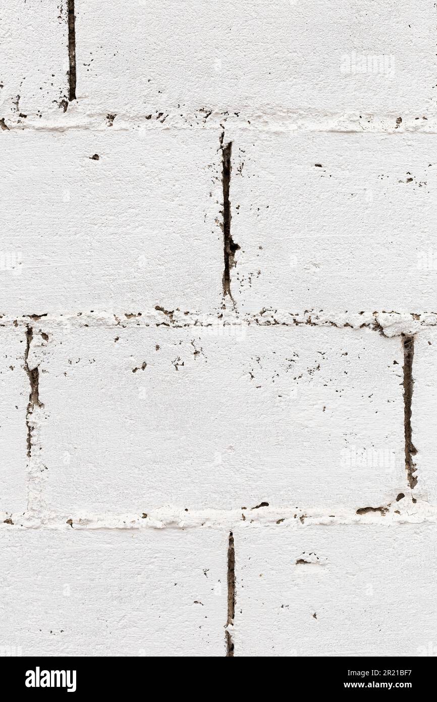 Rough and white wall made with big blocks or paver of cement and stone ...