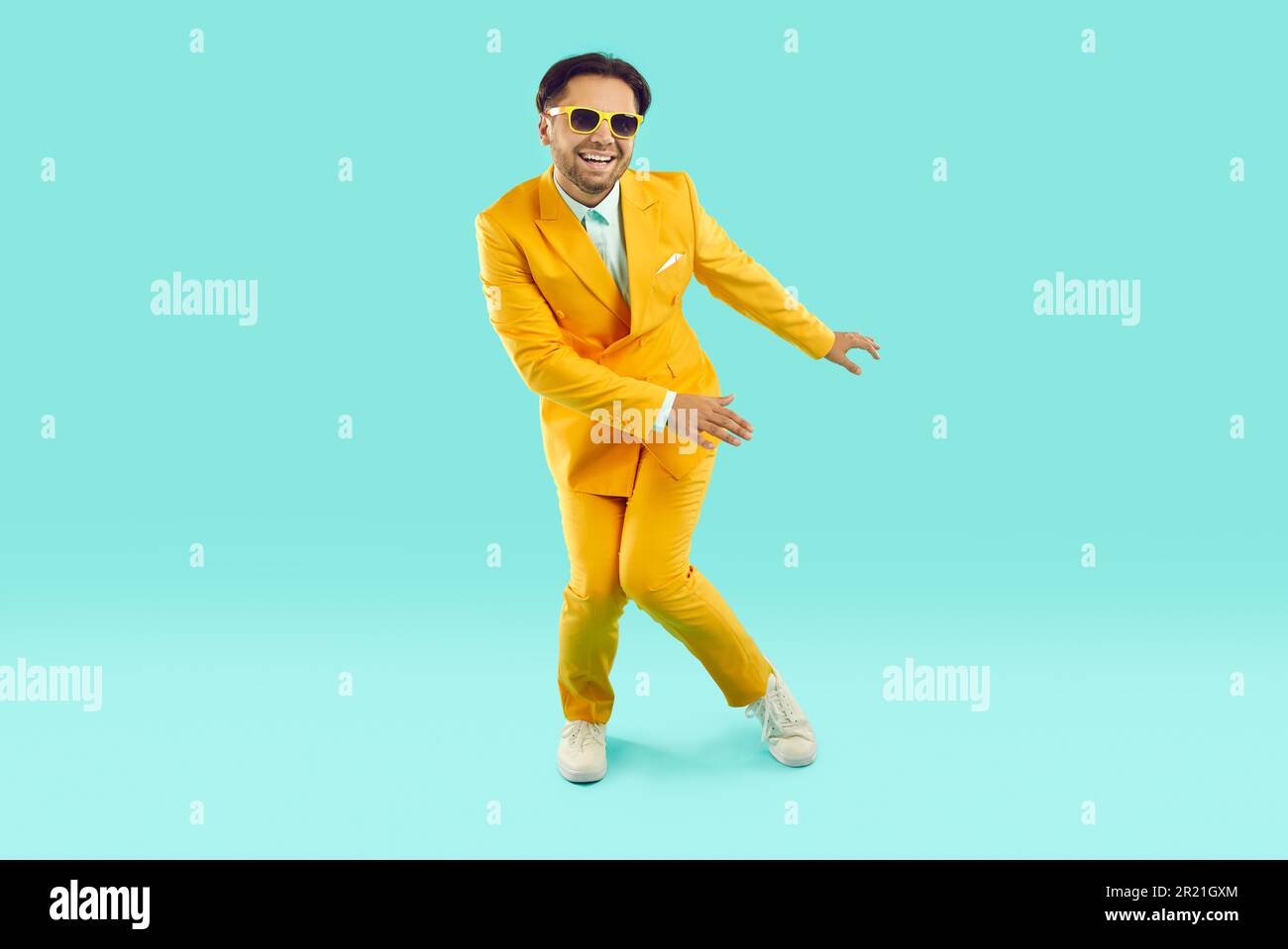 Happy excited young man dancing on studio background Stock Photo - Alamy