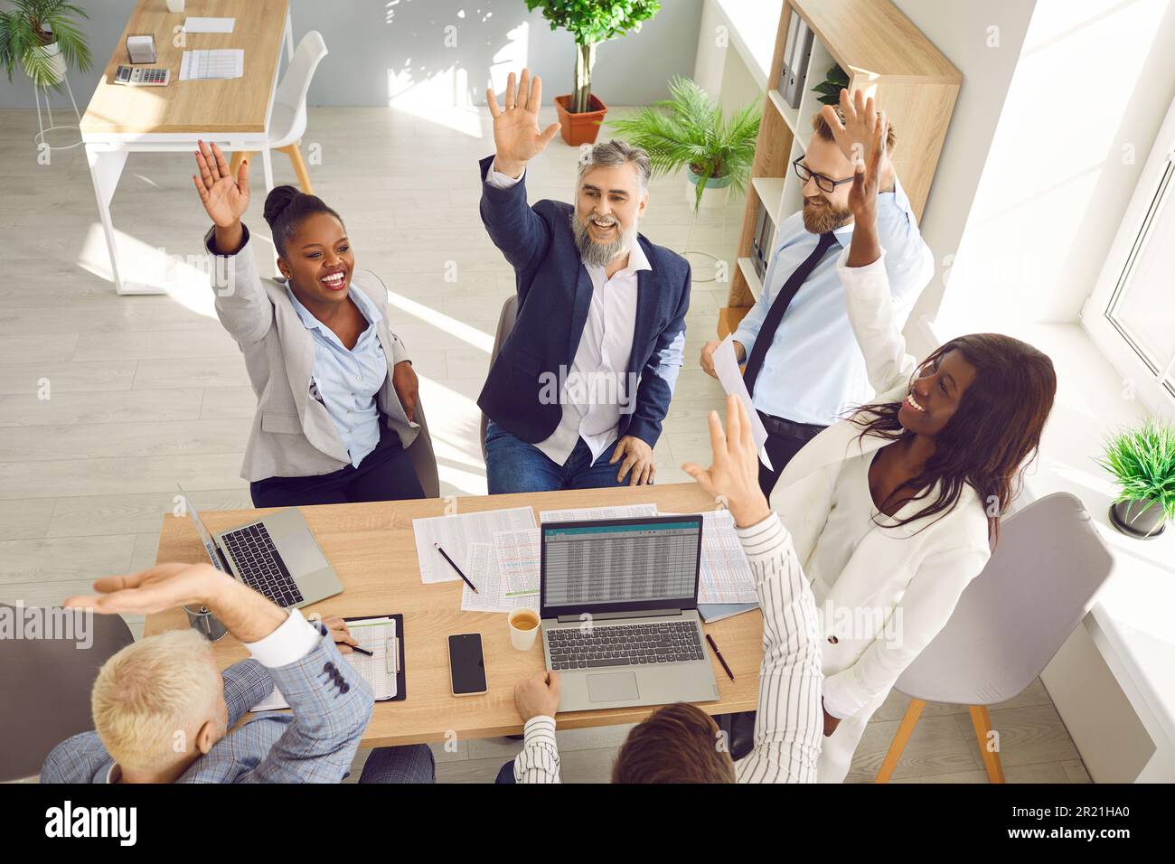 Top view of successful business team celebrating victory with their ...