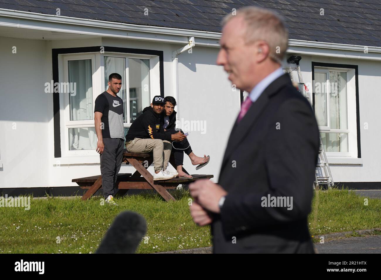 Asylum seekers watch Fianna Fail Senator Timmy Dooley speaking to the ...
