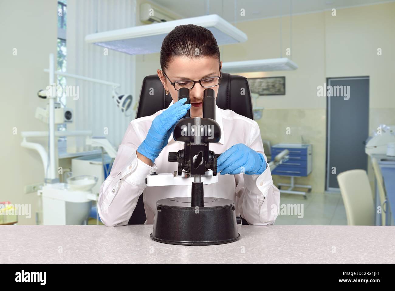 Woman looking into microscope eyepiece hi-res stock photography and ...