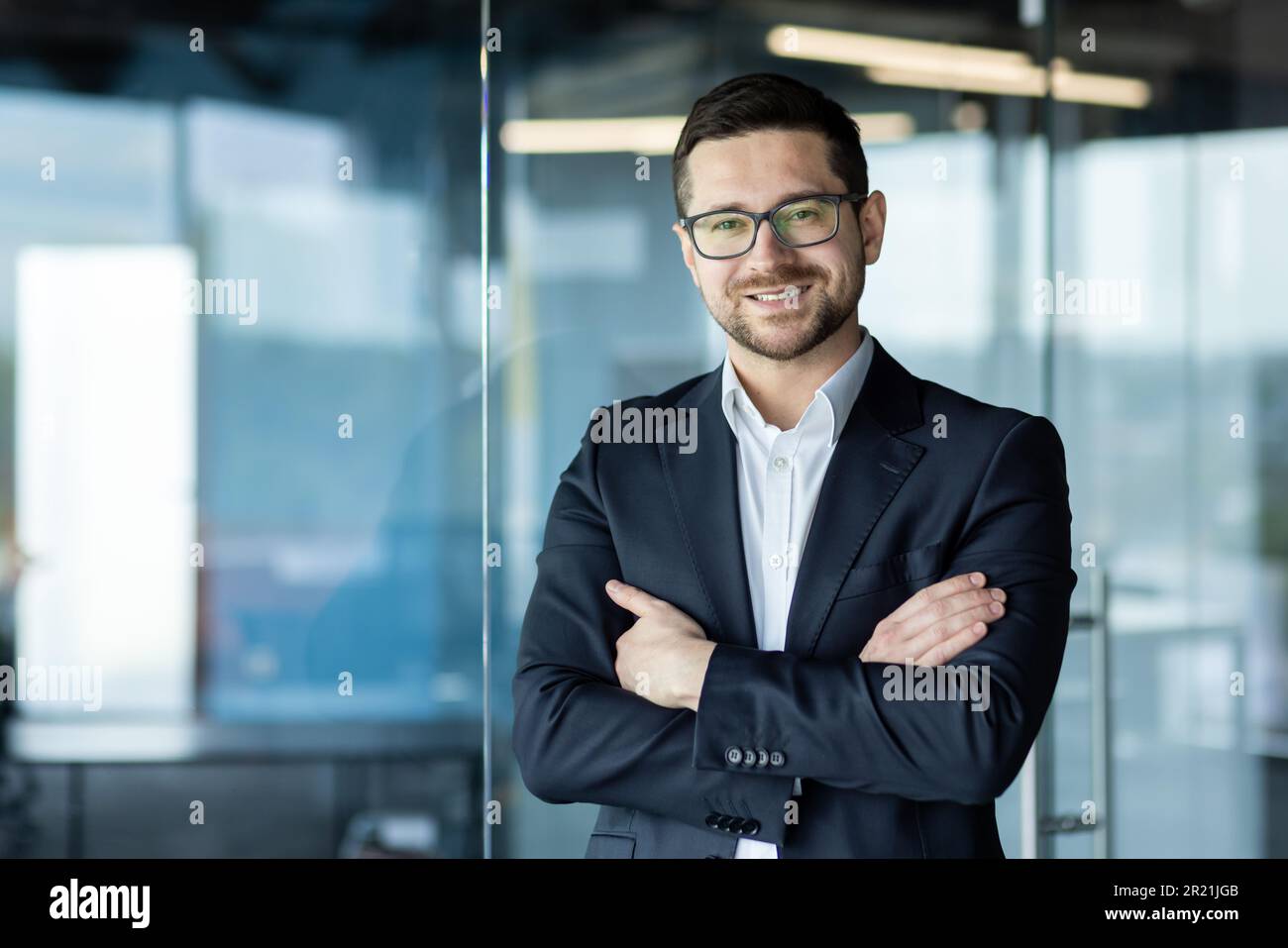 Portrait of a young self-confident male teacher, tutor, mentor standing ...