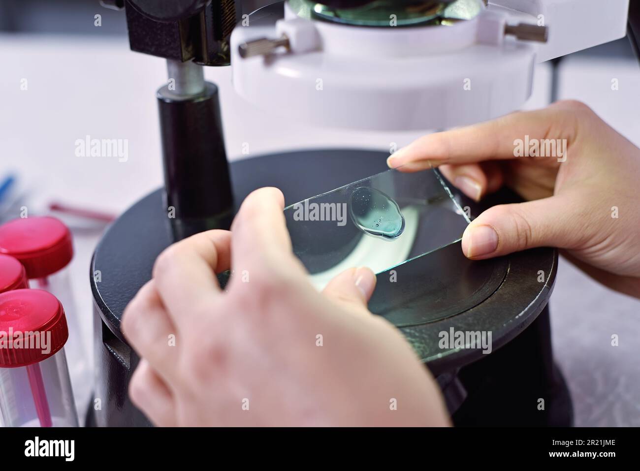 hands with microscope examining samples and liquid Stock Photo - Alamy