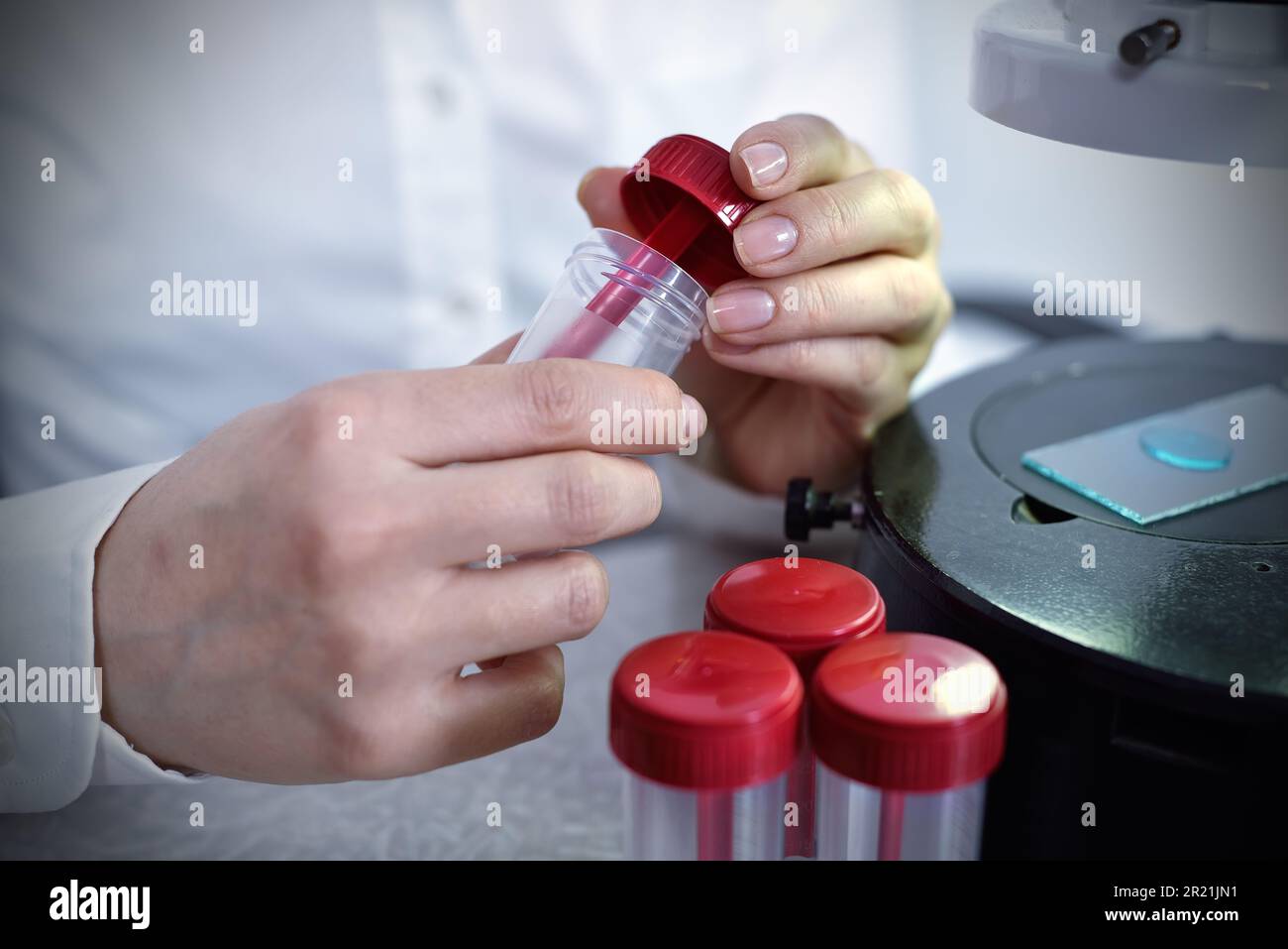 Scientist chemist examines the sample under a microscope Stock Photo ...