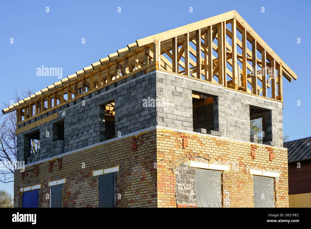 Unfinished residential house with brick and block walls and a wooden ...