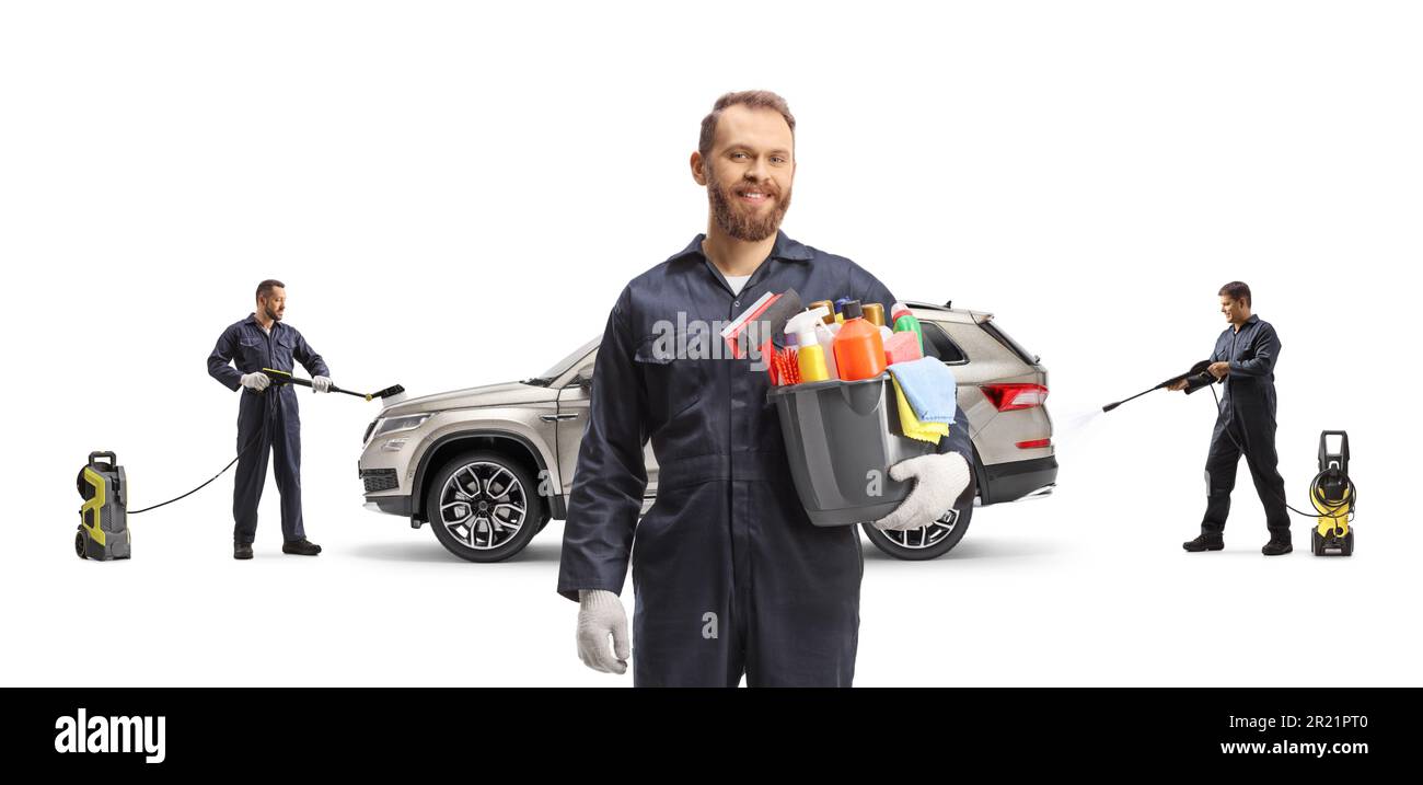 Car wash workers in uniforms cleaning a SUV isolated on white ...