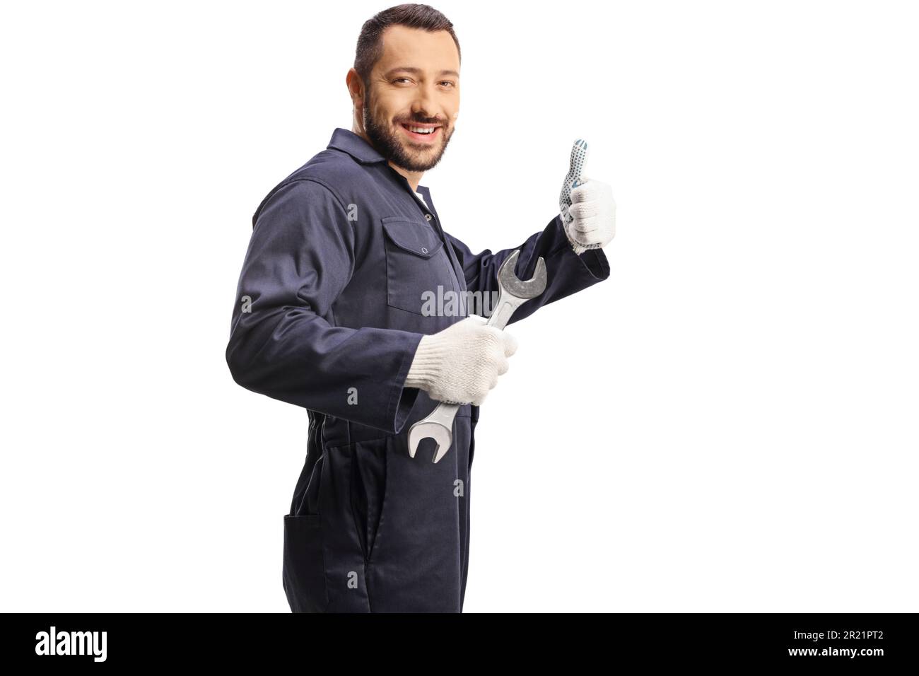Car mechanic holding a wrench and showing a thumb up sign isolated on ...