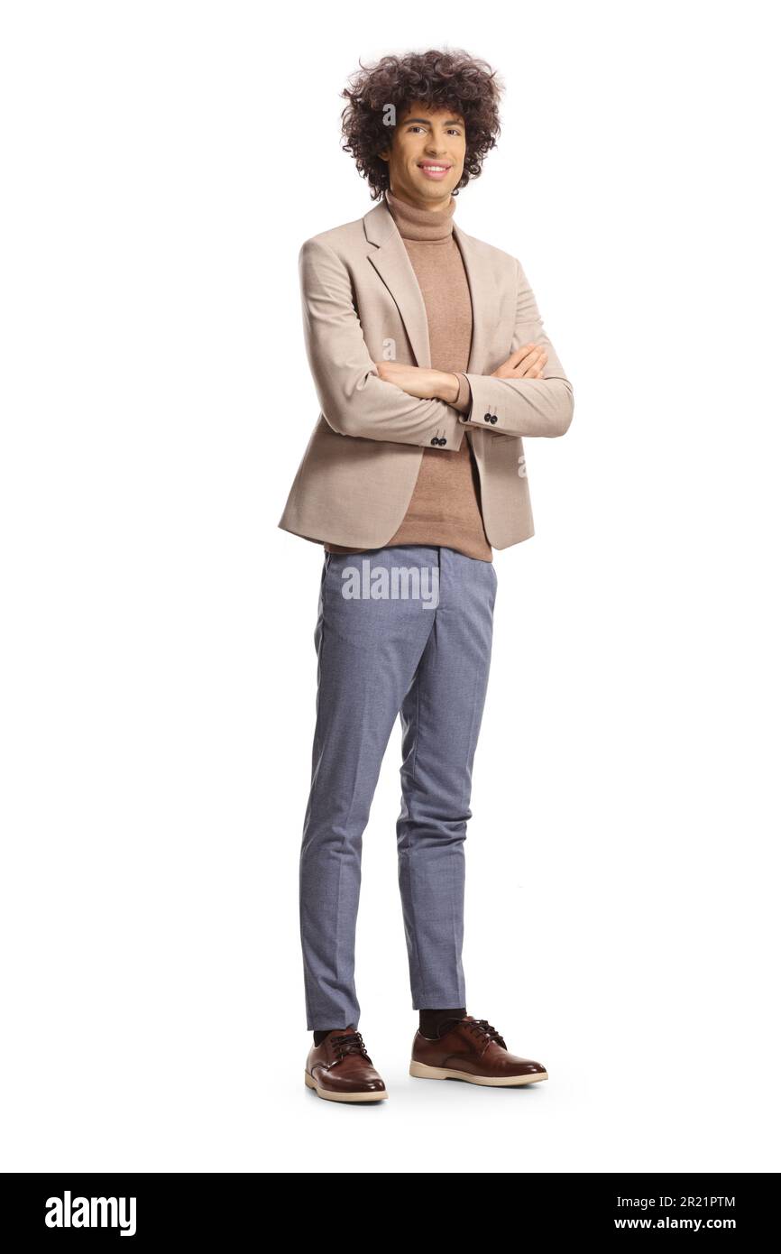 Tall young man with curly hair standing with folded arms and smiling ...