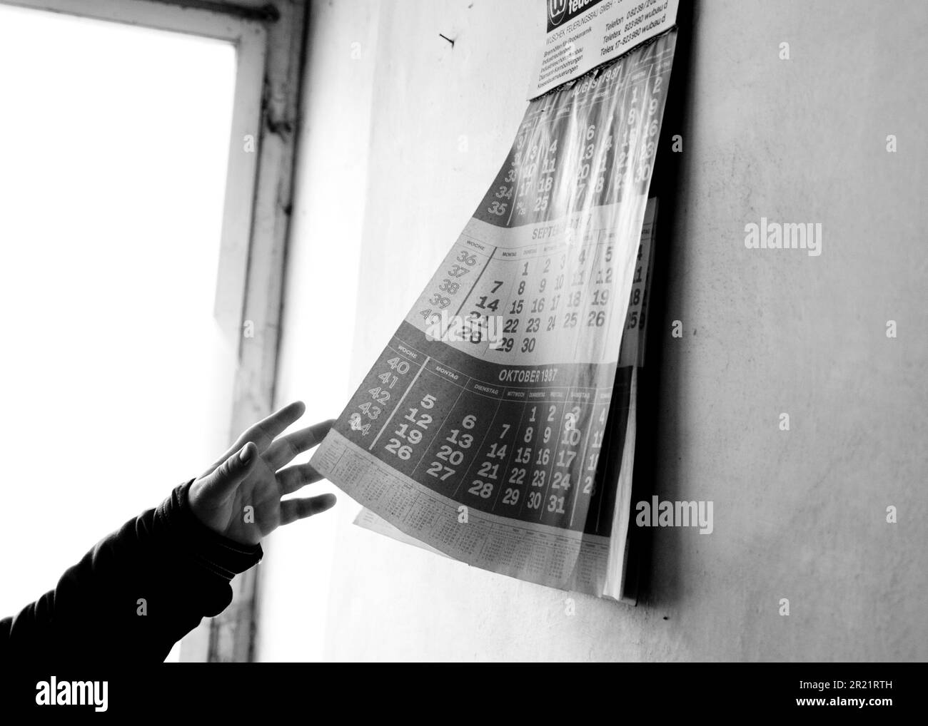 a hand reaching for an old calender Stock Photo - Alamy