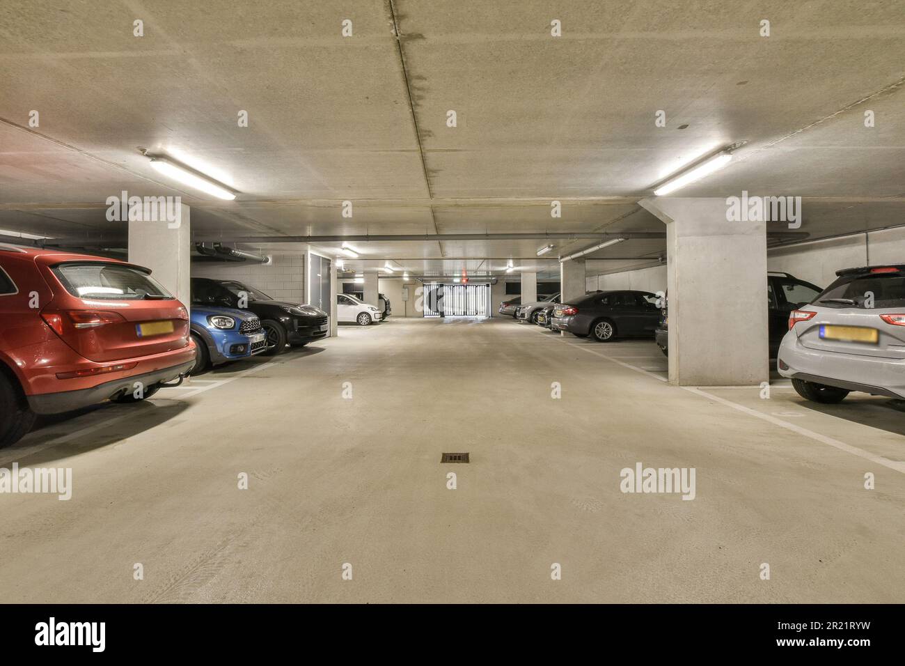 an underground parking with cars parked in the space between each other ...
