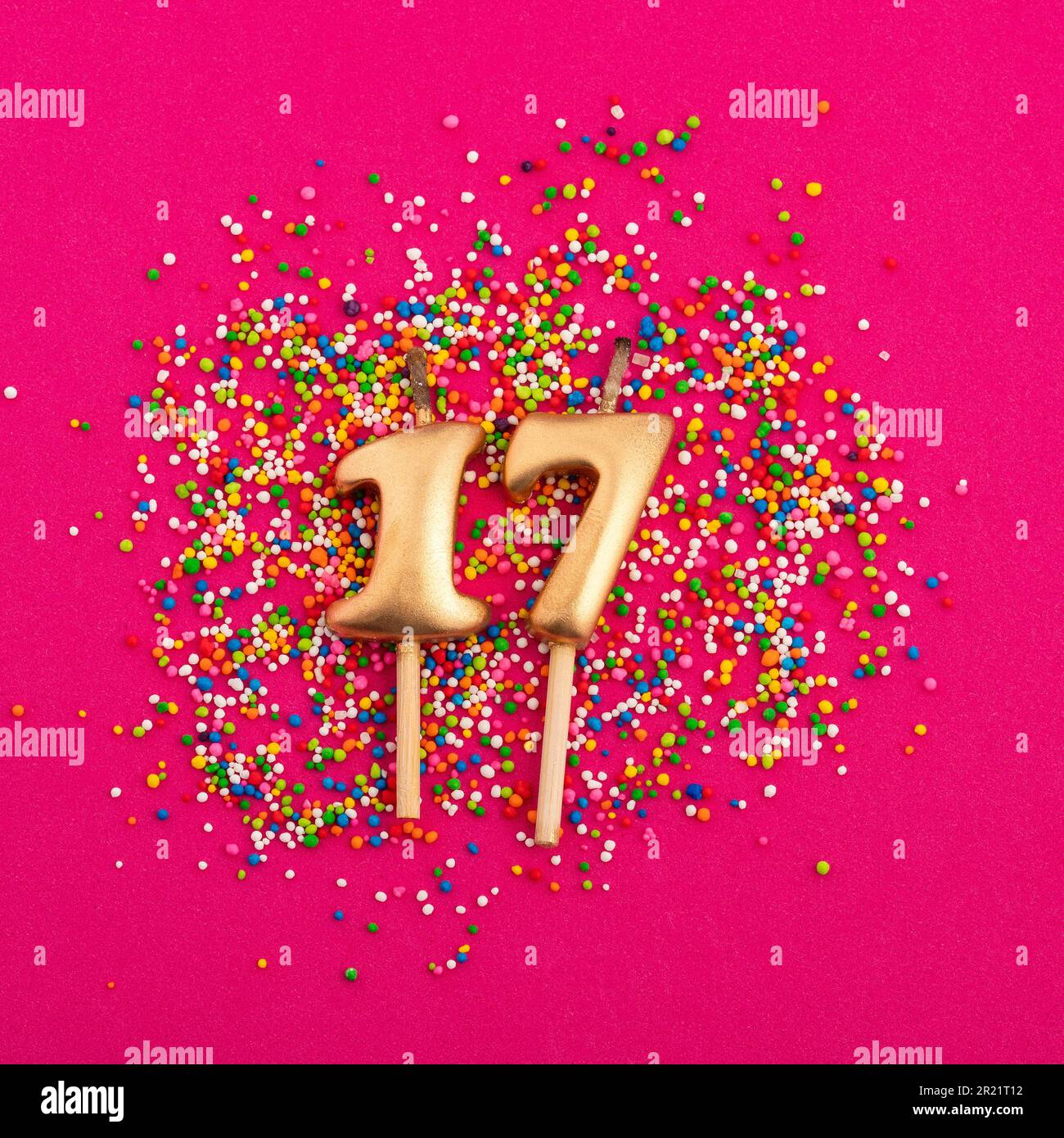 Candle number 17 - Birthday or anniversary on rhodamine red background ...