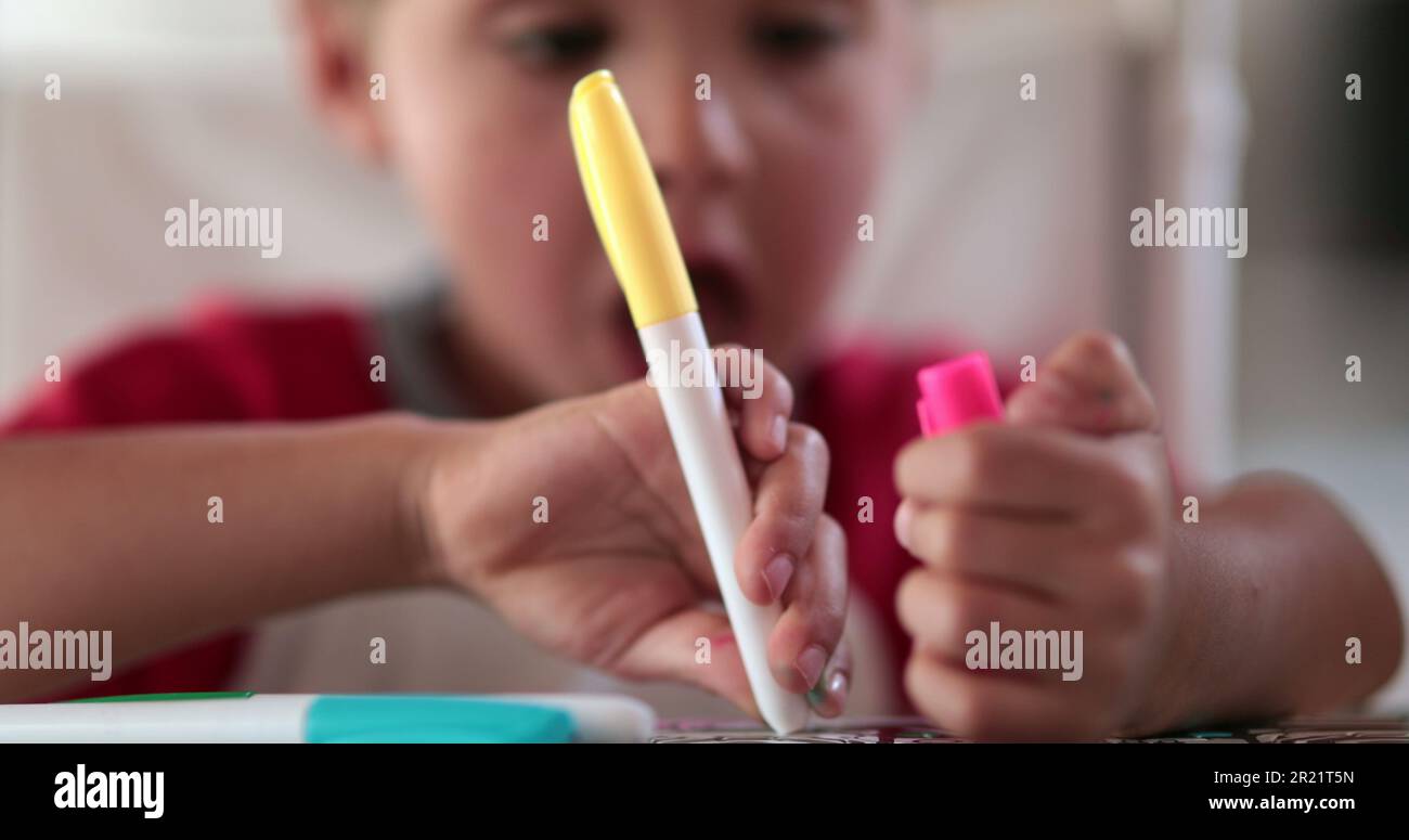 Child drawing with yellow color pen. Toddler boy crafting and creating ...