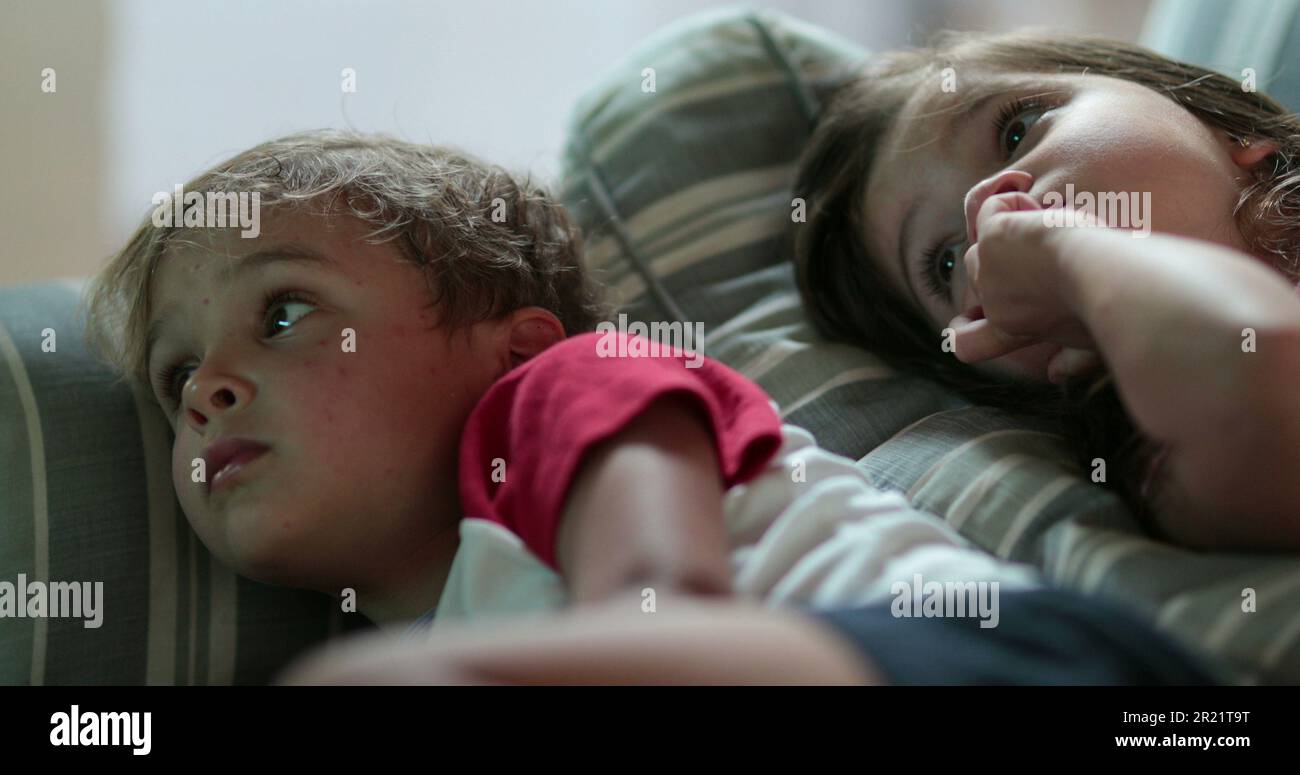 Children faces hypnotized by screen watching cartoons at night before ...