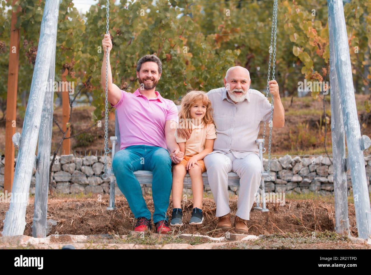 Men generation family playing on swing together Three different ...