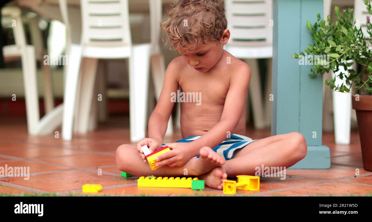 Child playing with building blocks. Construction block for baby toddler ...