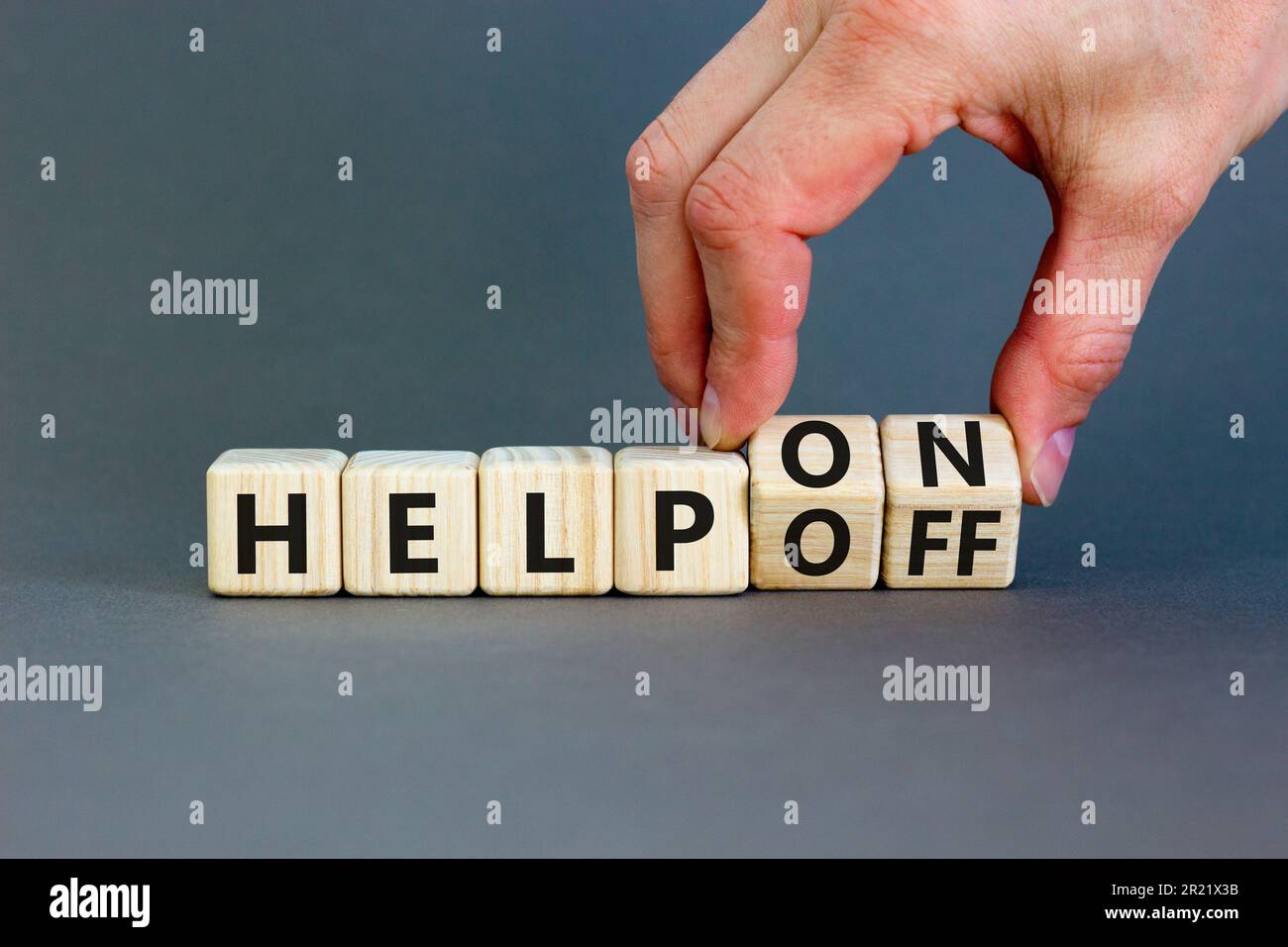 Help on or off symbol. Businessman turns wooden cubes and changes word ...