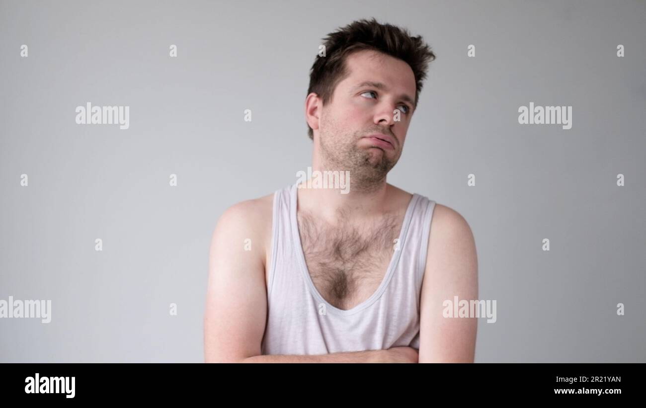 the tired European young man looks dejectedly, without strength and ...