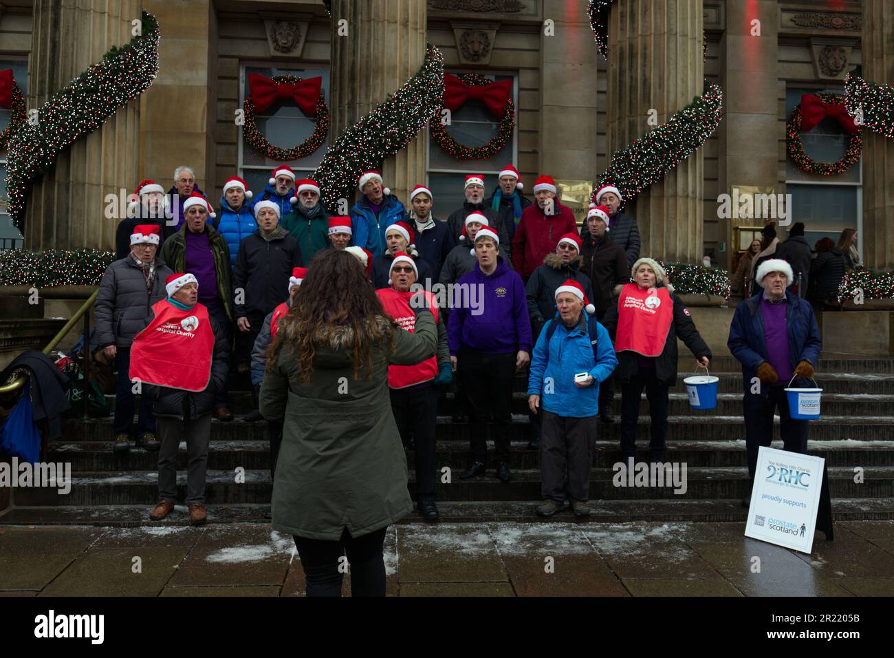 A cheerful group of people gathered on a staircase to perform a ...