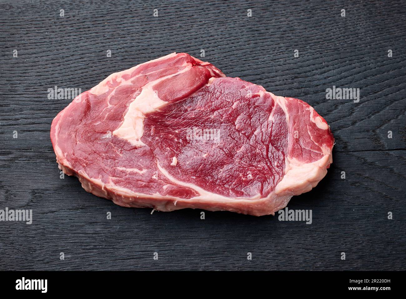 fresh raw beef entrecote steak on black wooden board, top view Stock ...