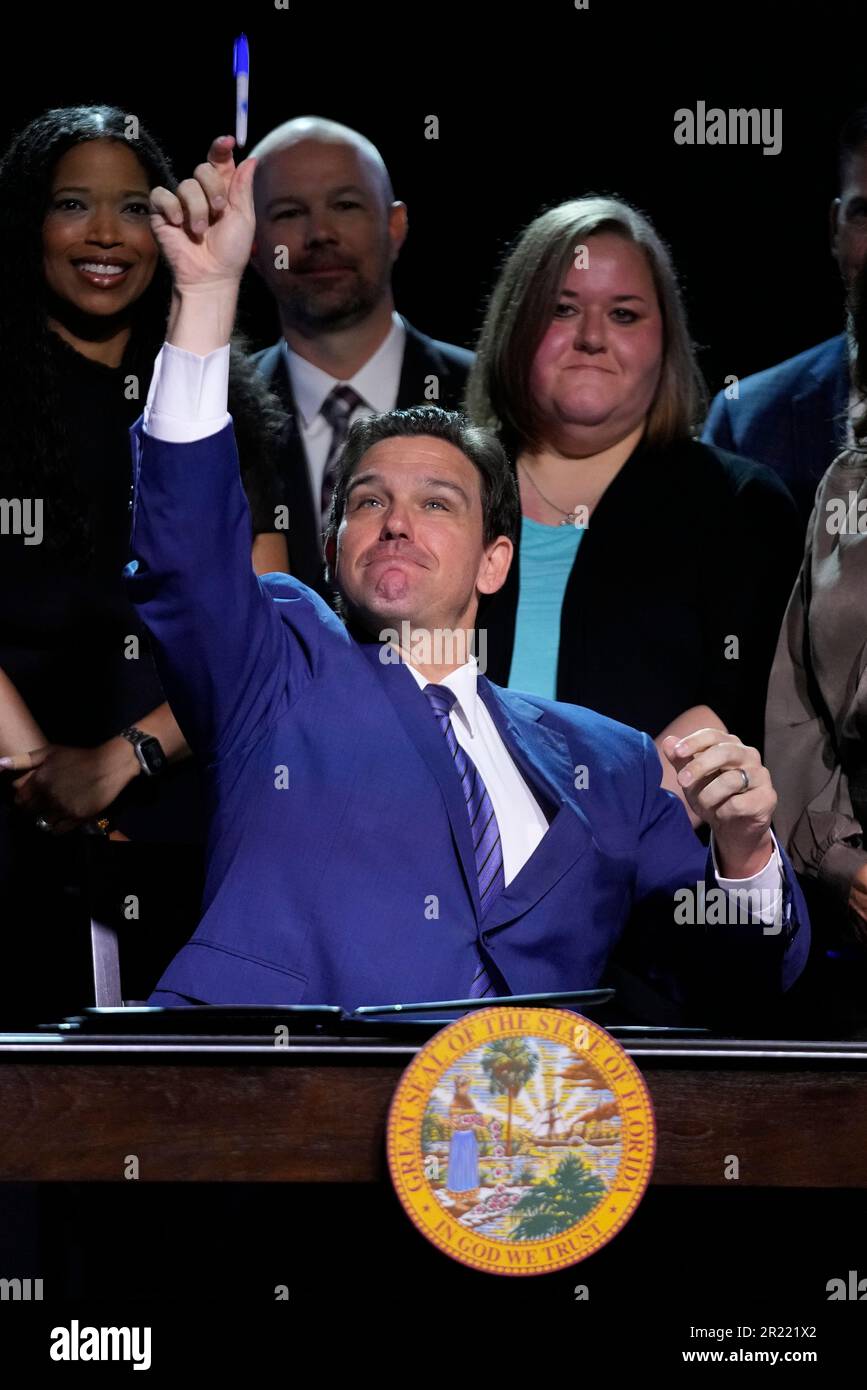 Florida Gov. Ron DeSantis throws a marker into the audience after ...