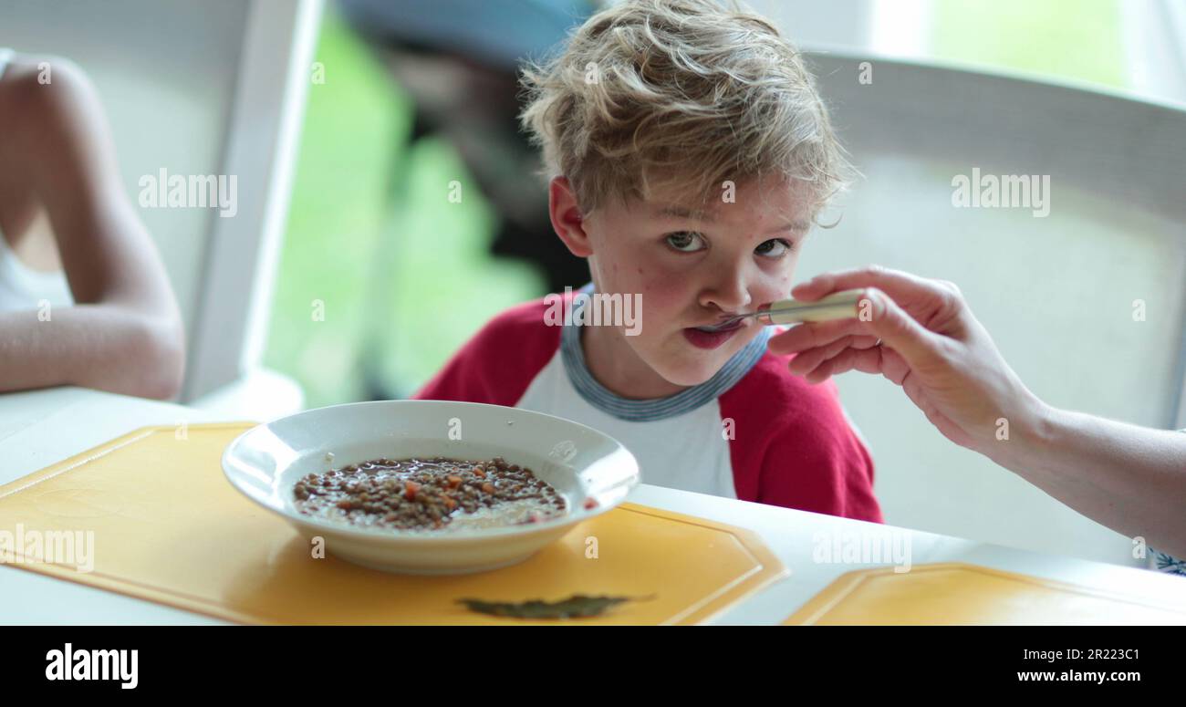 Mother feeding child toddler baby boy supper meal dinner Stock Photo ...
