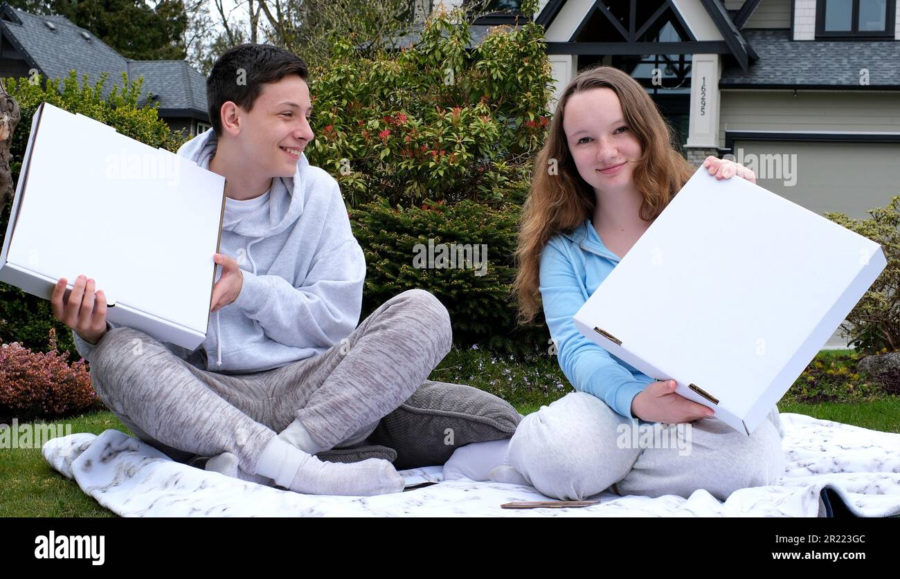 teenagers in hands with boxes of pizza advertising delicious laughter ...