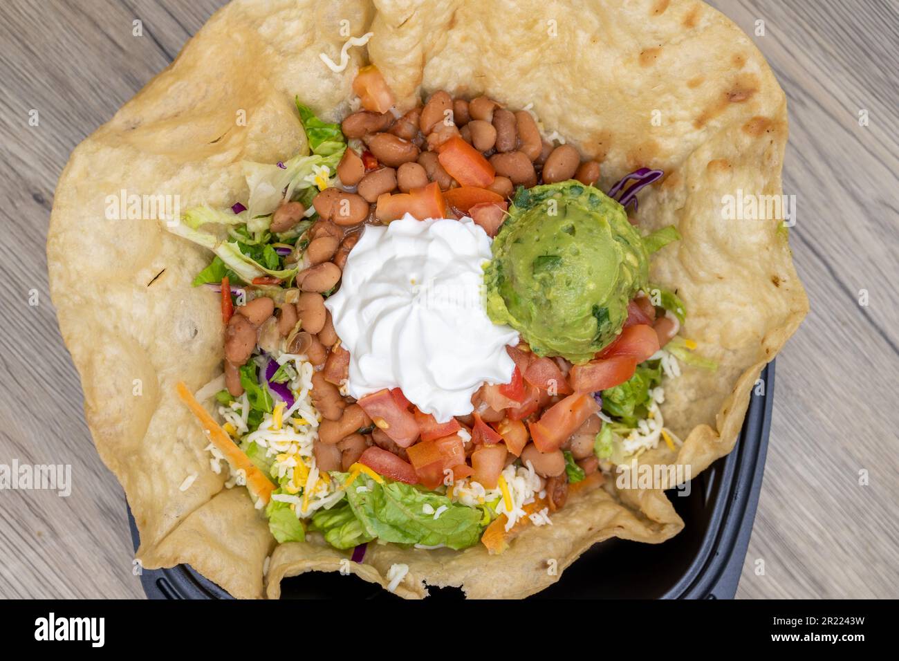 Overhead view of crispy tostada shell contains this generous taco salad ...