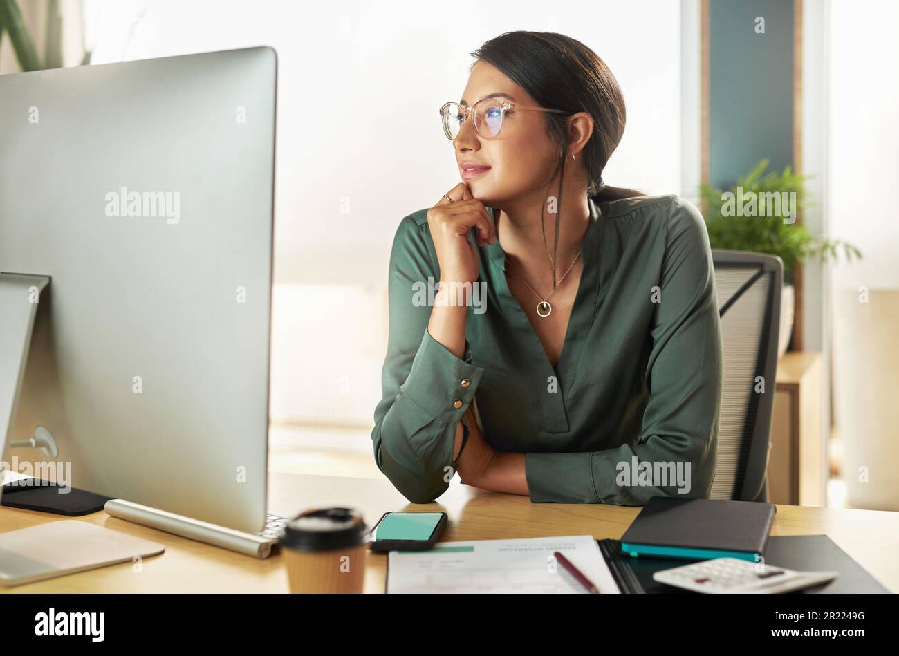 Hm we might need to make some changes. a young businesswoman looking at ...