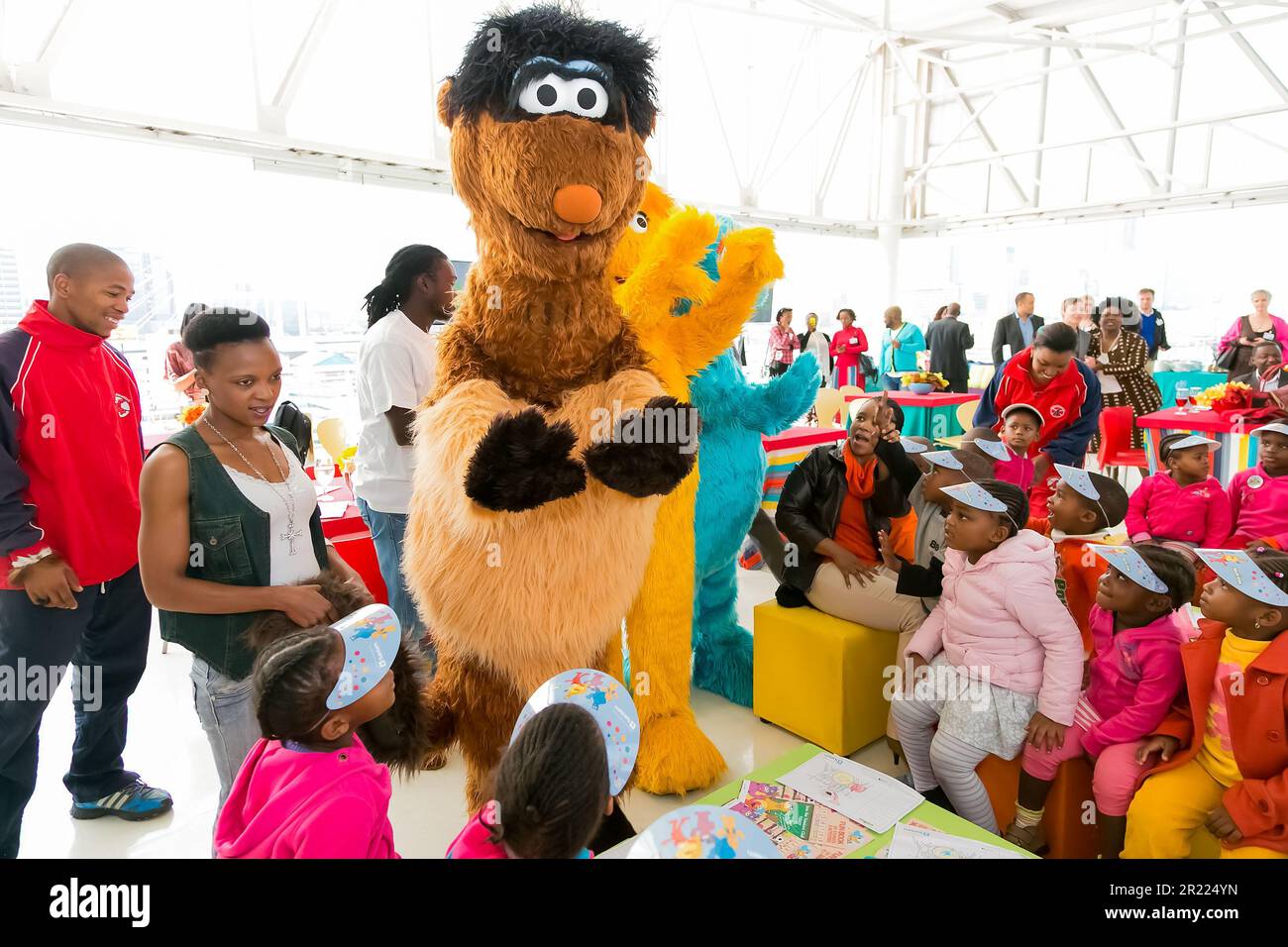 A large Sesame Street style character performing for African children ...