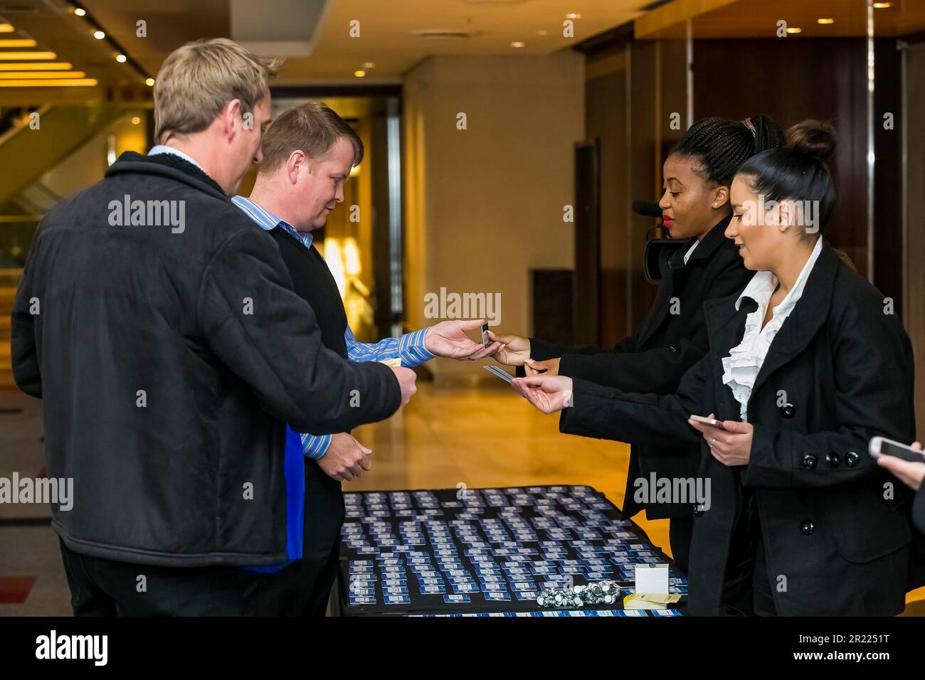 The two professional males registering and receiving badges at a ...