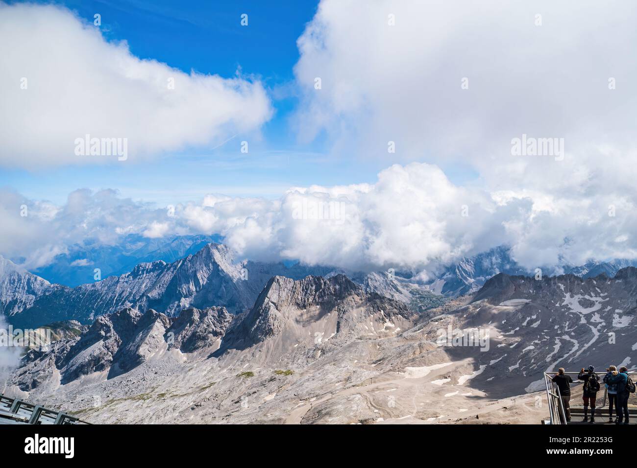 Tourists on the lookout platform on the Zugspitze summit during summer ...