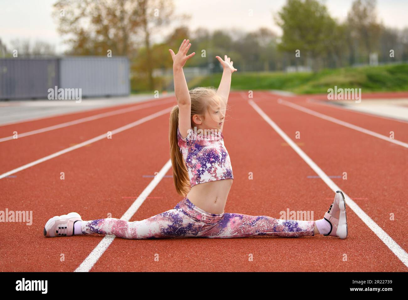 A girl in a legging doing splits at the stadium Stock Photo - Alamy