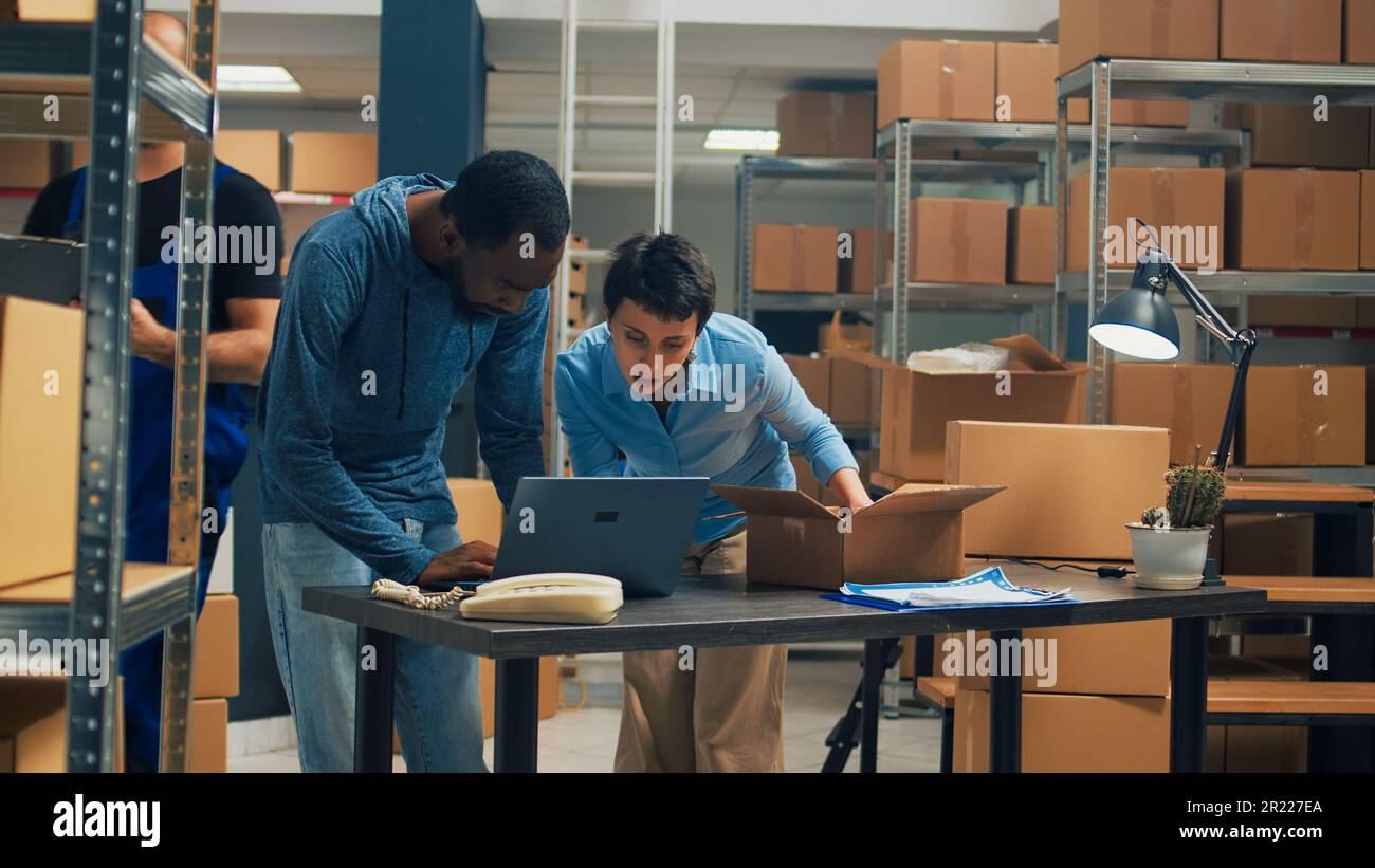 Business partners putting products in boxes for stock shipment Stock ...
