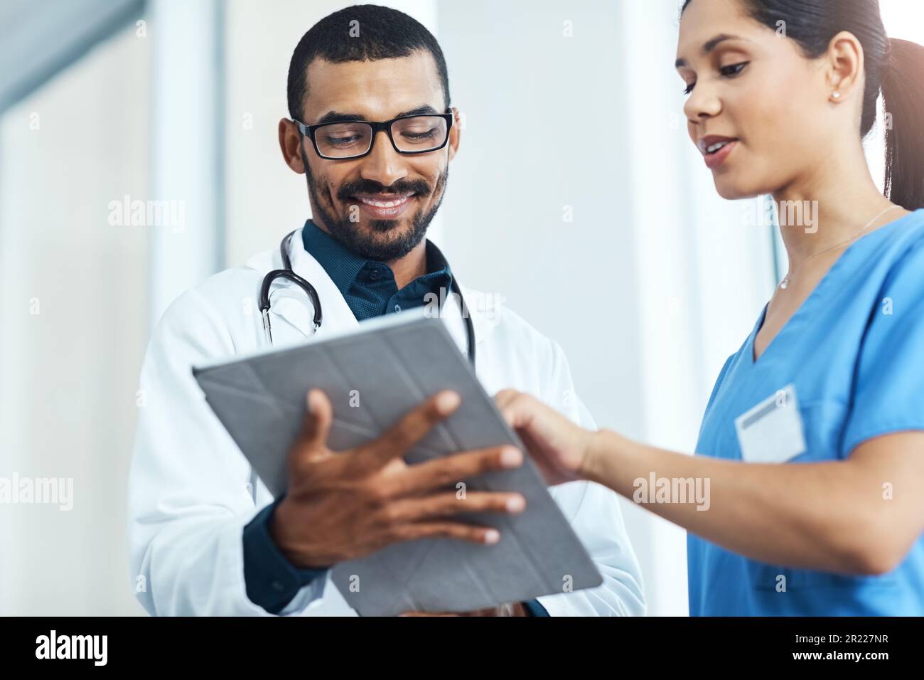 What do the lab tests say. two young doctors using a digital tablet in ...
