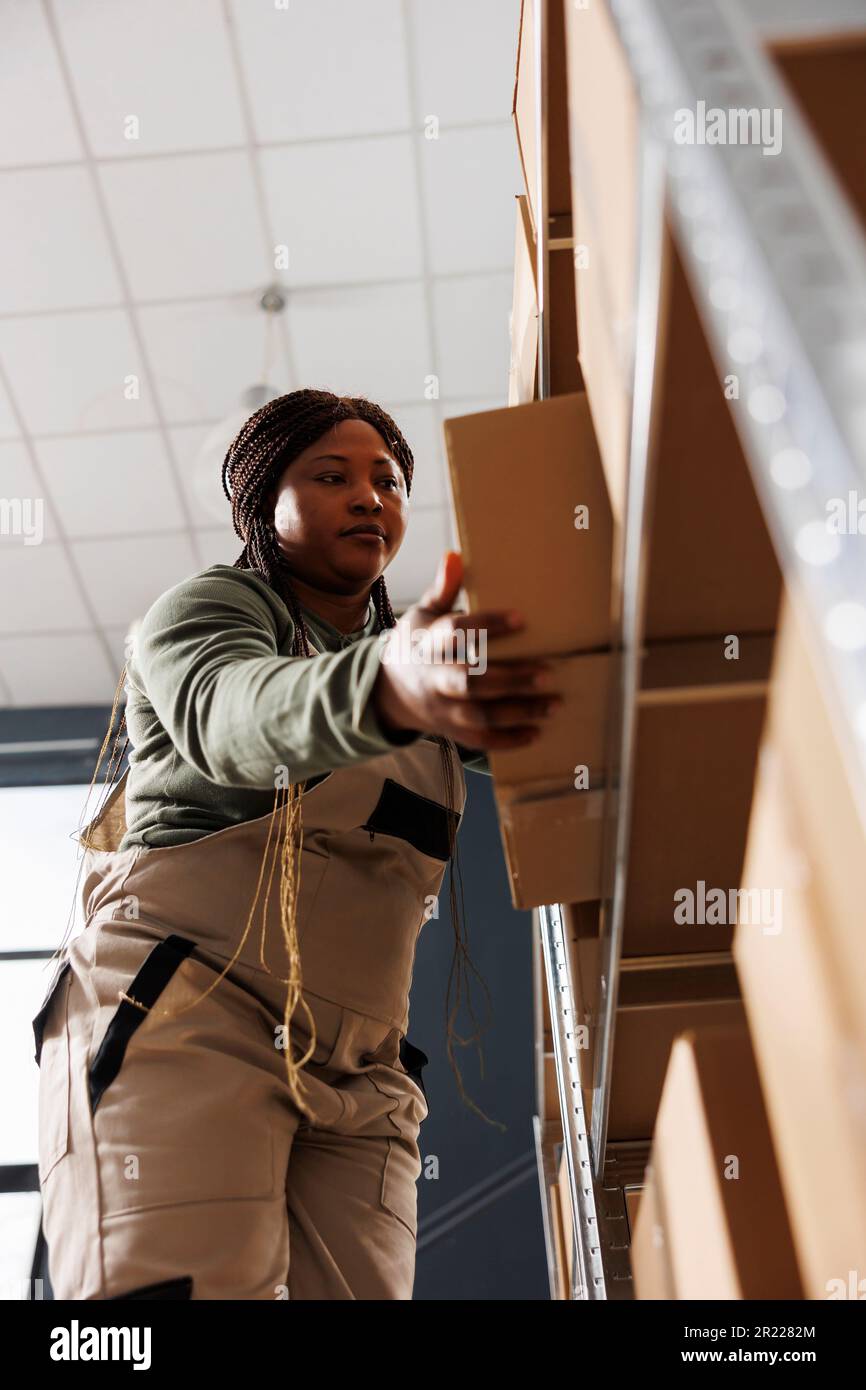 Storage room worker employee taking out cardboard boxes Stock Photo - Alamy