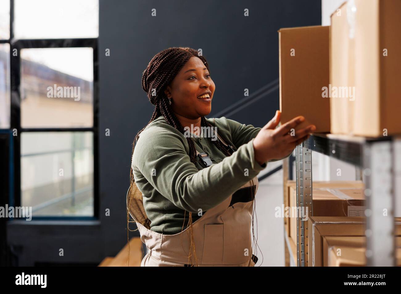Storage room supervisor working with cardboard boxes Stock Photo - Alamy