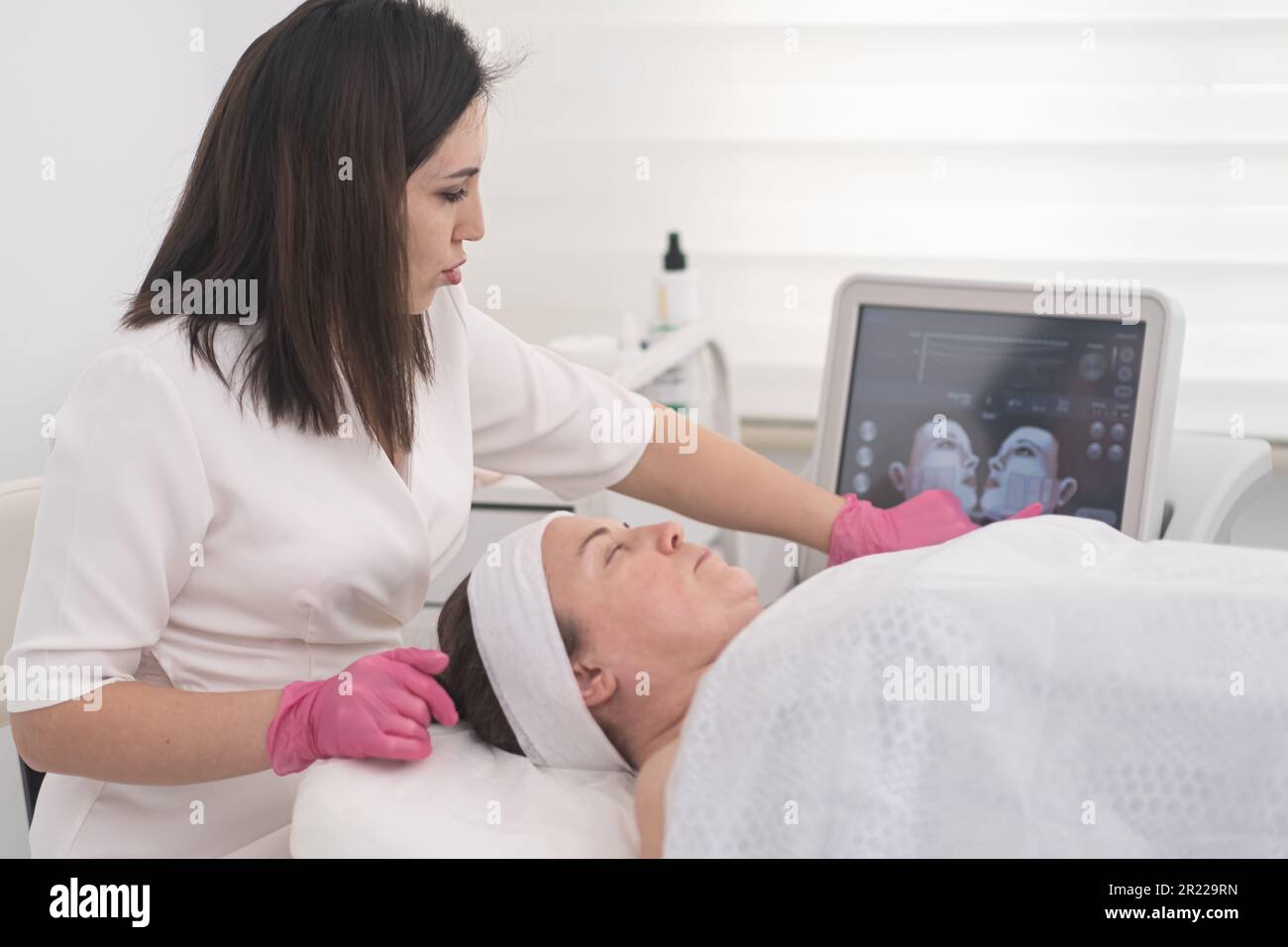 woman receiving facial treatment ultrasound lifting laser machine ...