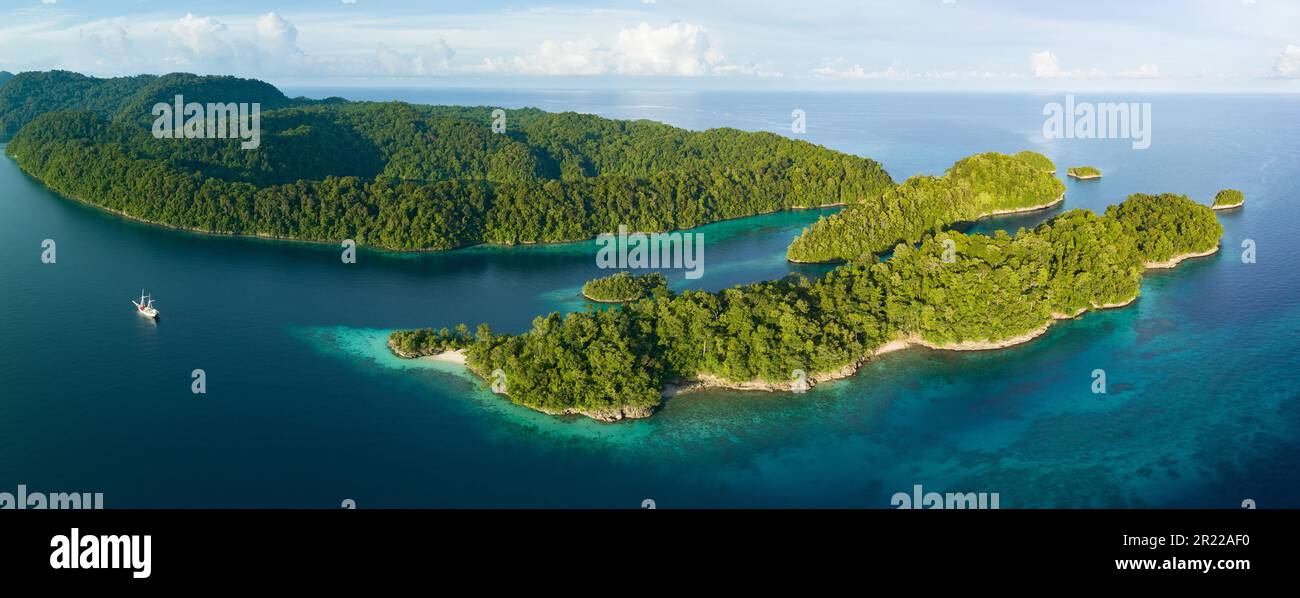 Beautiful tropical islands, surrounded by reefs, rise from West Papua's ...