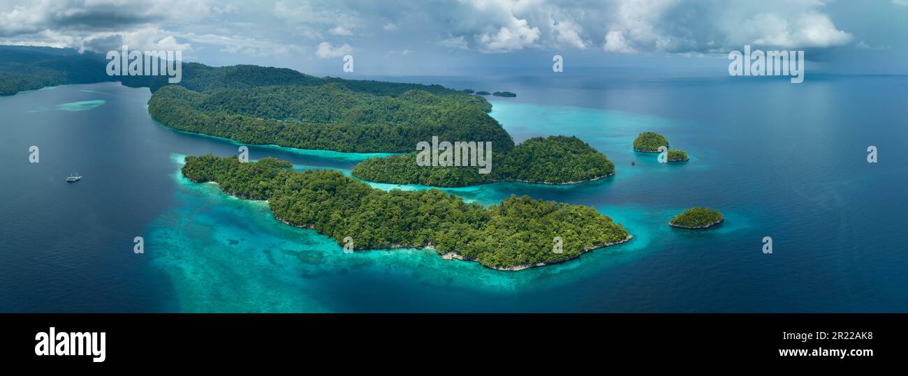 Beautiful tropical islands, surrounded by reefs, rise from West Papua's ...
