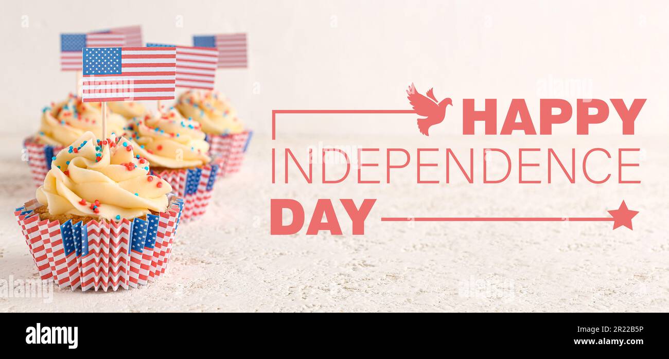 Tasty patriotic cupcakes with USA flags on light background. Happy ...