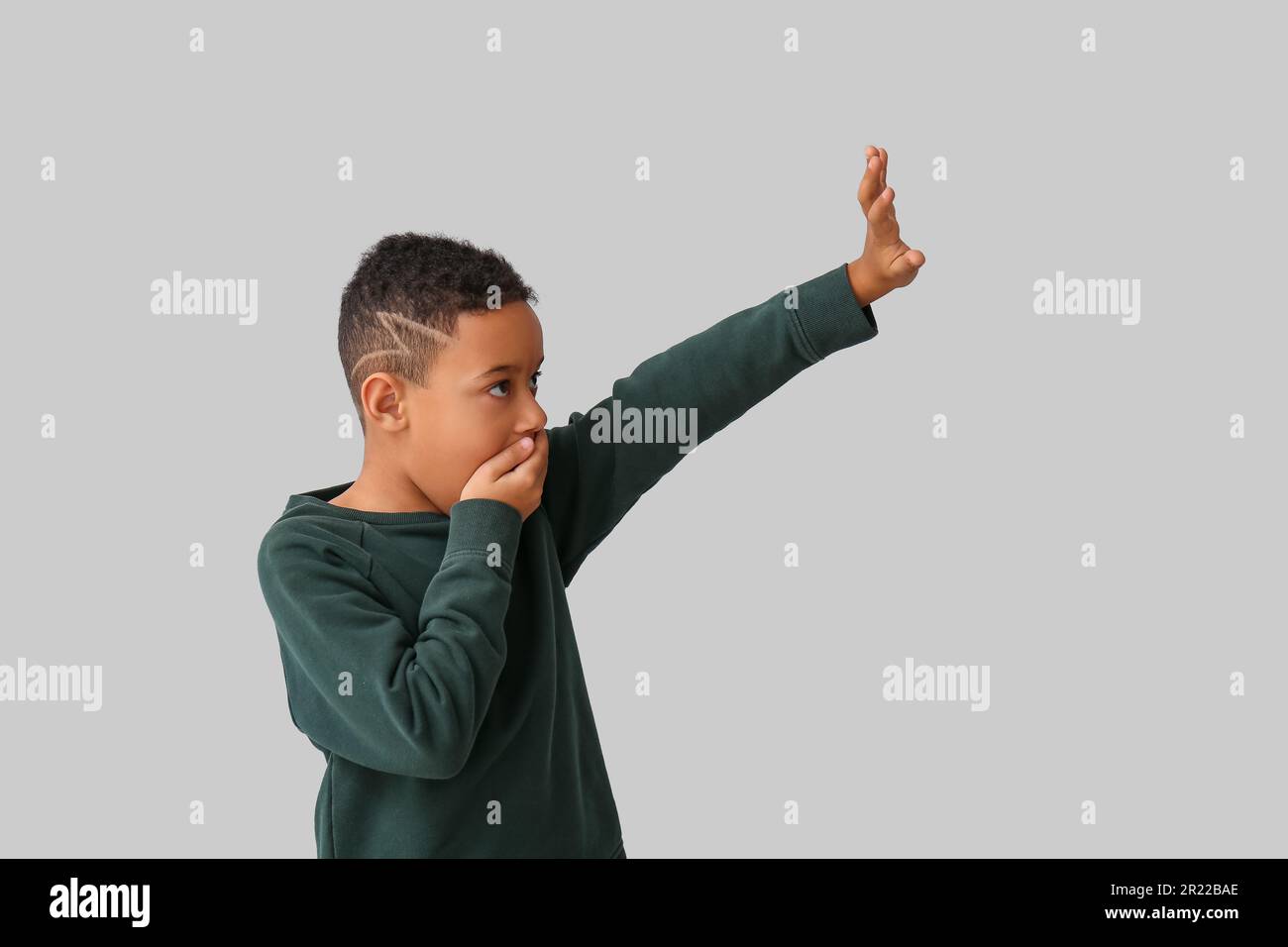 Scared little African-American boy on light background Stock Photo - Alamy