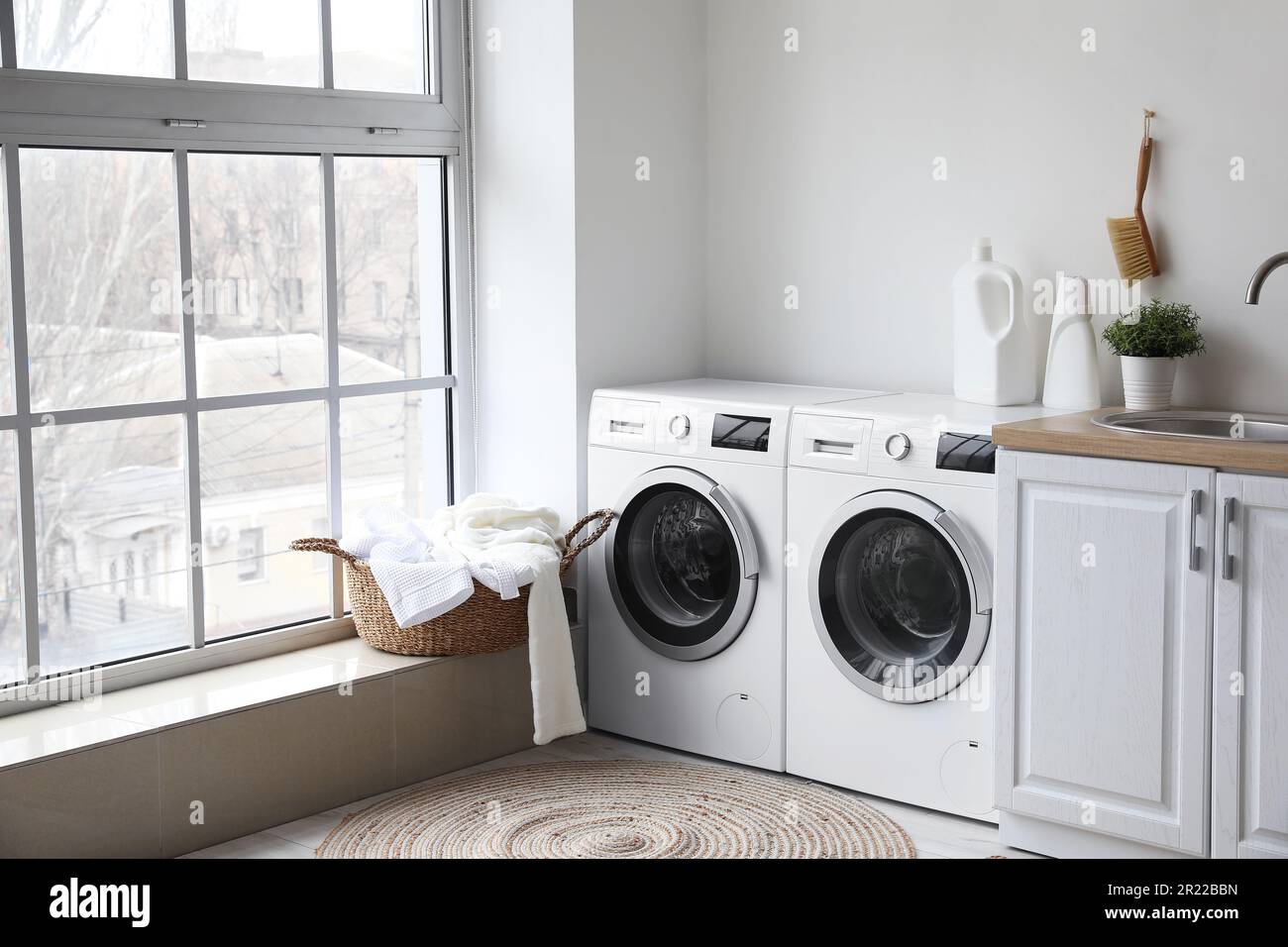 Interior of laundry room with washing machines and dirty clothes Stock ...