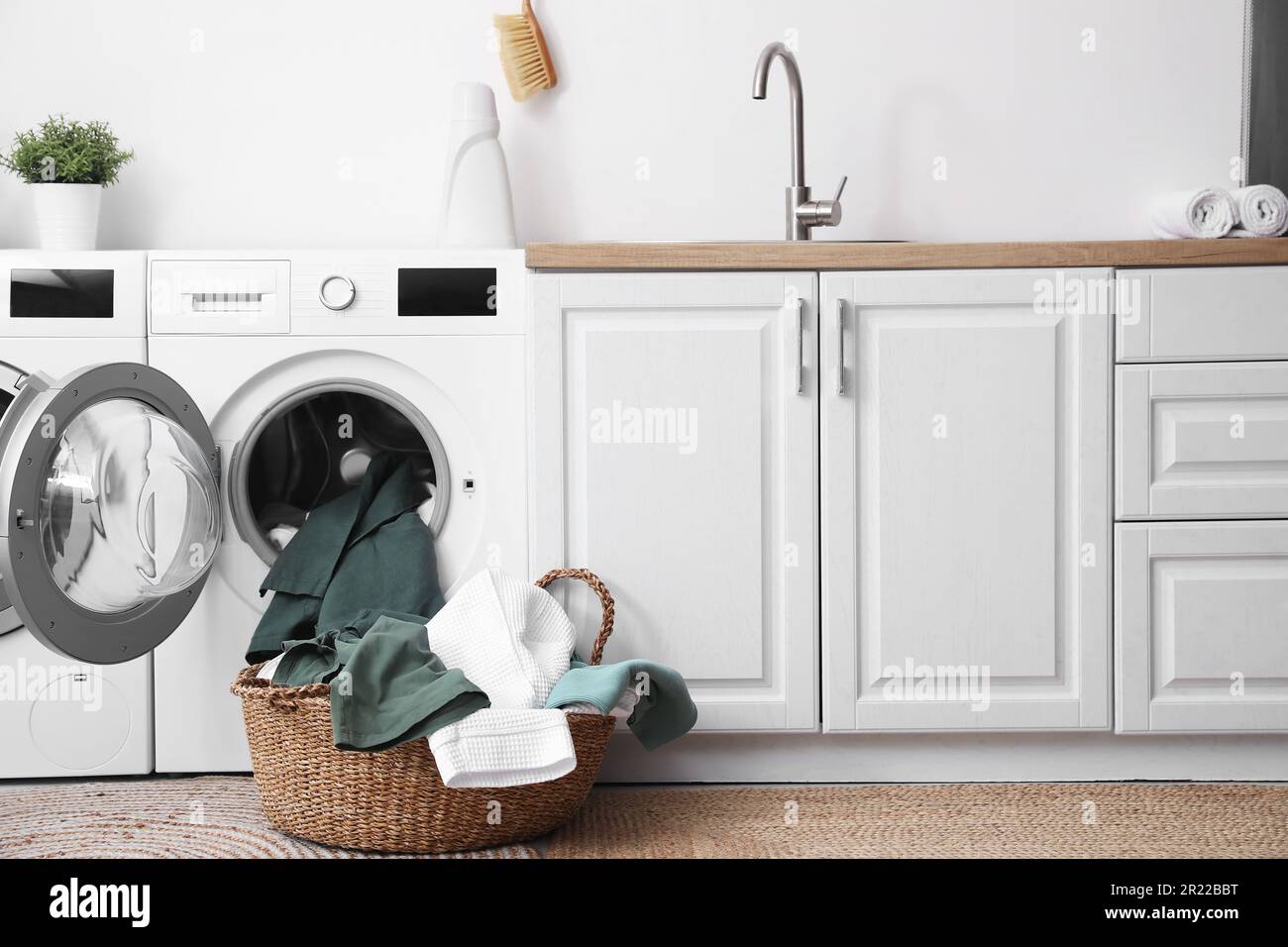 Modern washing machines with dirty clothes in laundry room Stock Photo ...