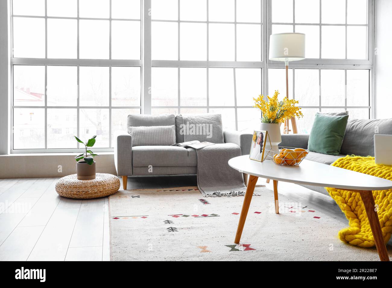 Interior of bright living room with cozy sofas near big window Stock ...