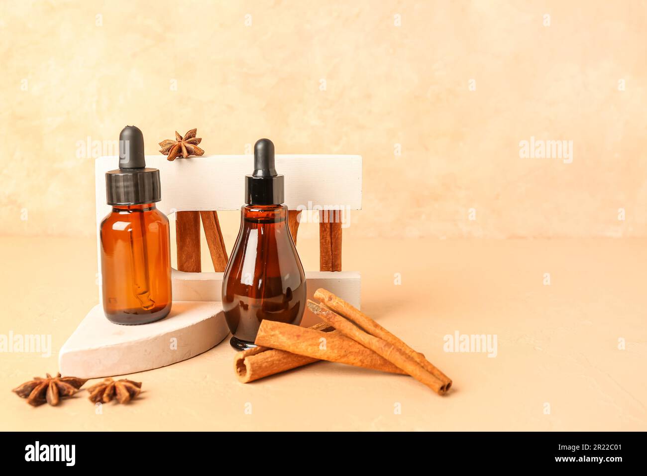 Composition with bottles of cosmetic products, cinnamon sticks, anise ...