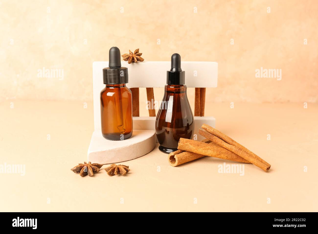 Composition with bottles of cosmetic products, cinnamon sticks, anise ...