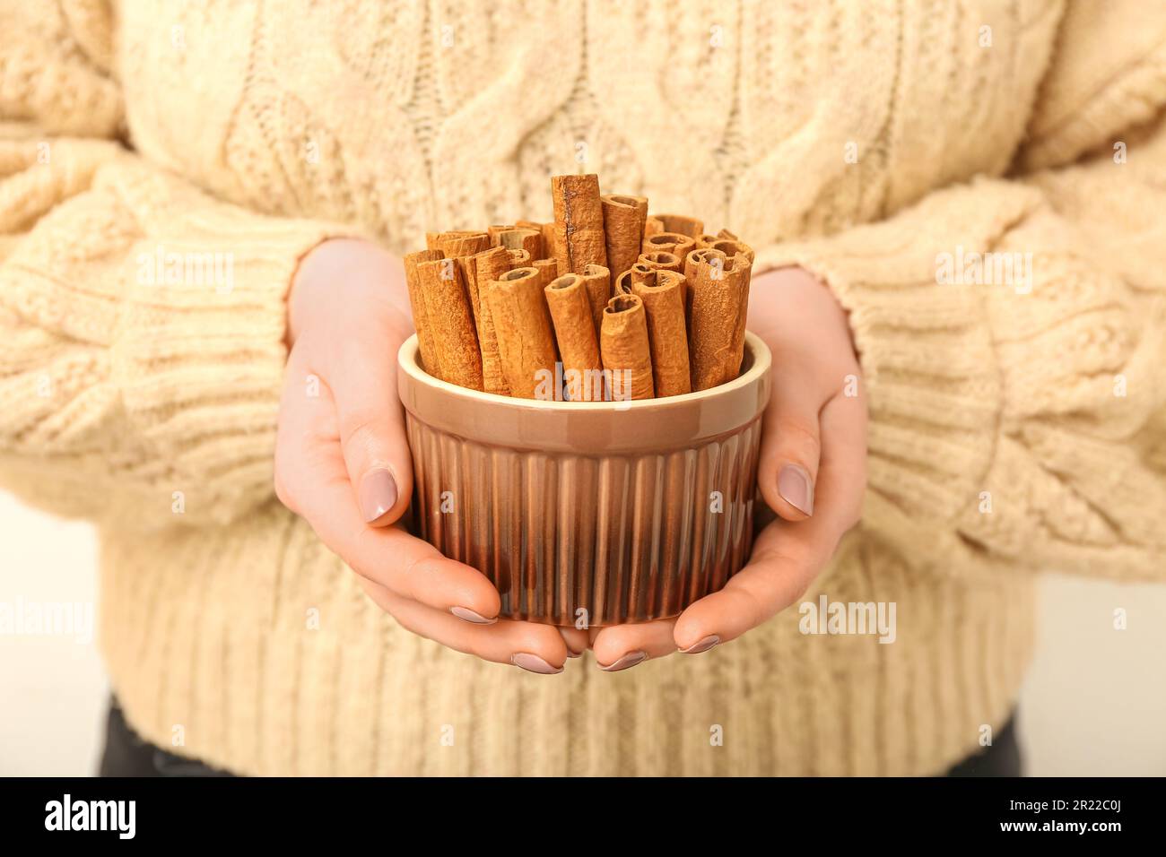 Woman holding cinnamon sticks hi-res stock photography and images - Alamy