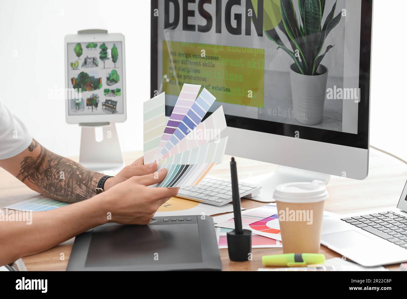 Male graphic designer working with color palettes in office, closeup ...