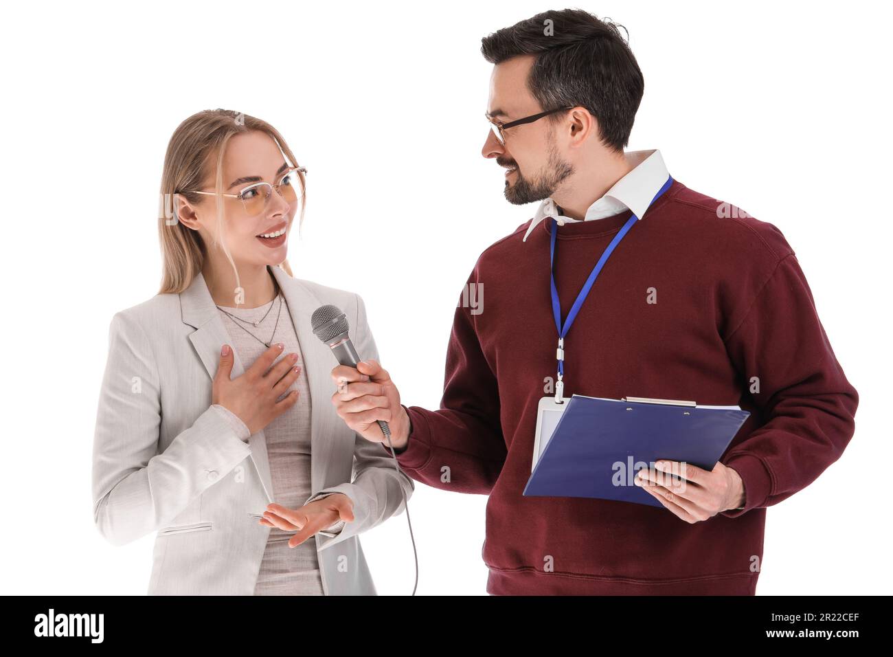 Male journalist with microphone having an interview with woman on white ...