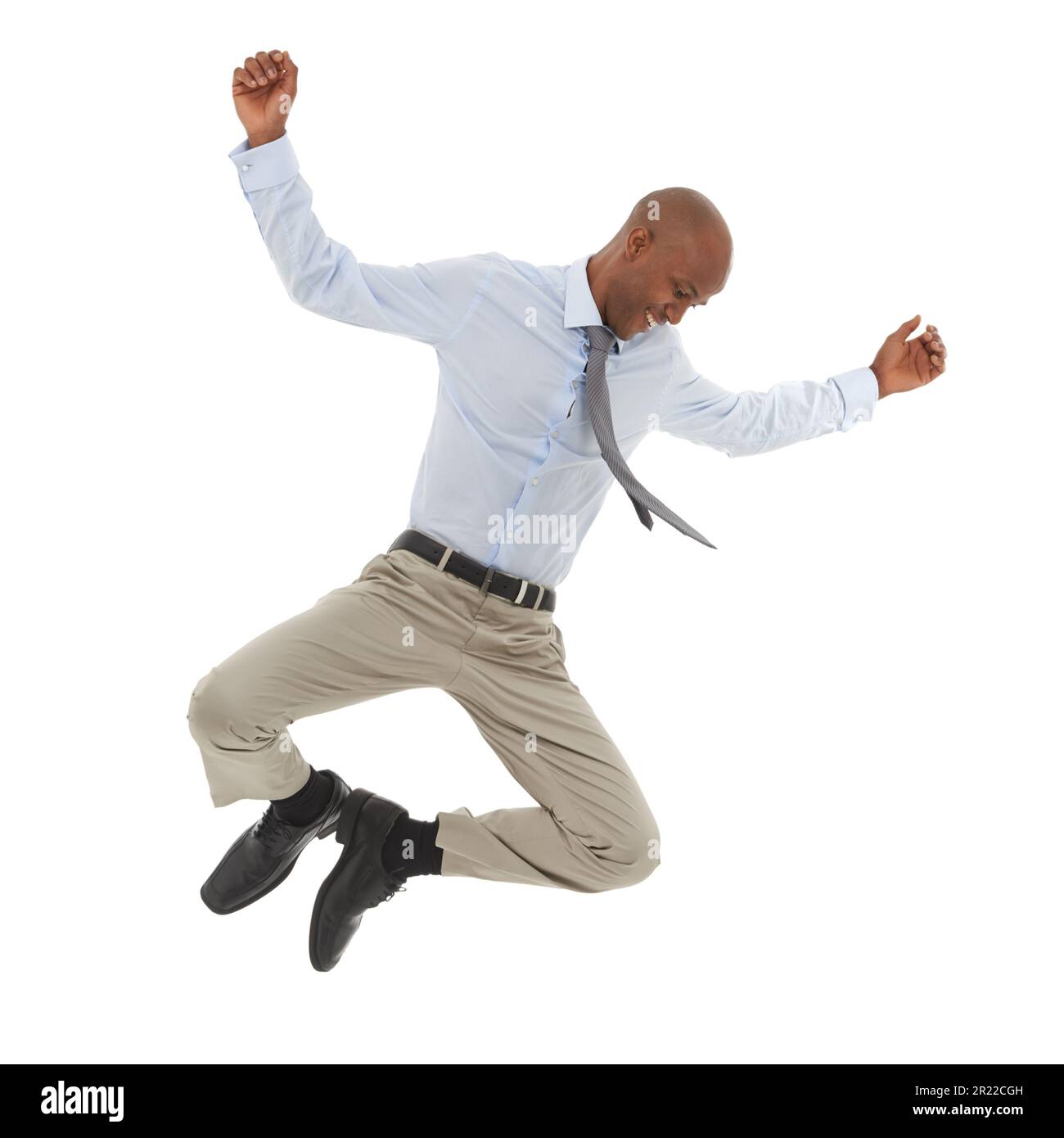 Flying high. An African-American businessman jumping joyfully in the ...